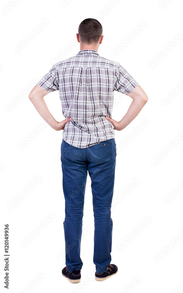 Back view of handsome man in shirt. Standing young guy in jeans. Rear ...