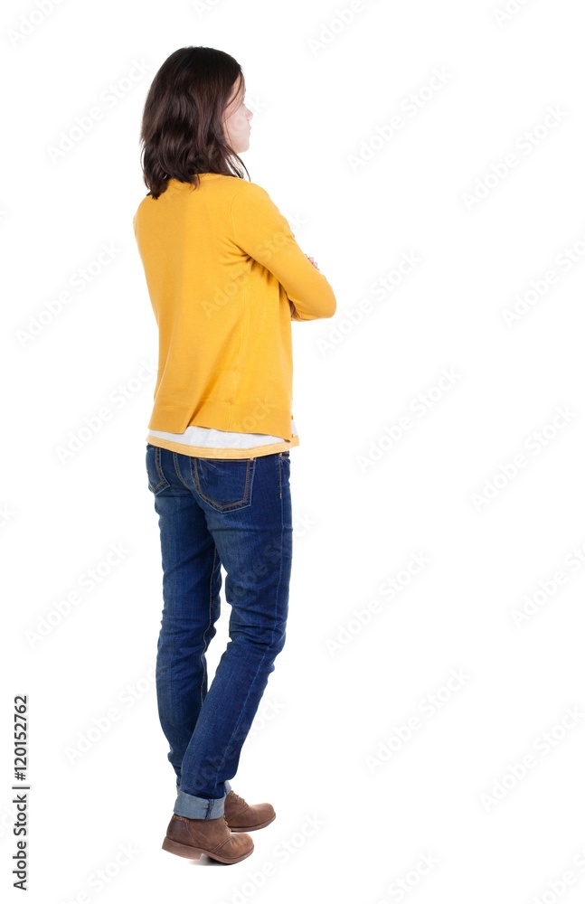 back view of standing young beautiful brunette woman in yellow pullover ...