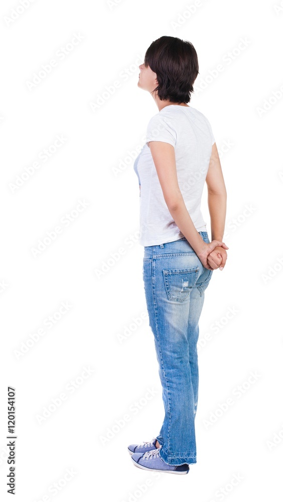 back view of standing young beautiful brunette woman. girl watching ...