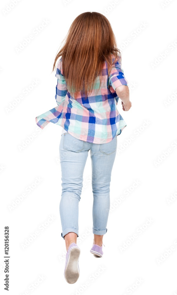 back view of running woman. beautiful redhead girl in motion. backside ...