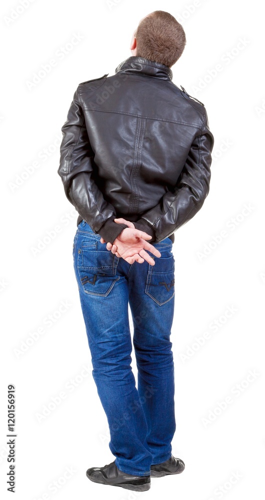 Back view of handsome man in jacket looking up. Standing young guy in ...