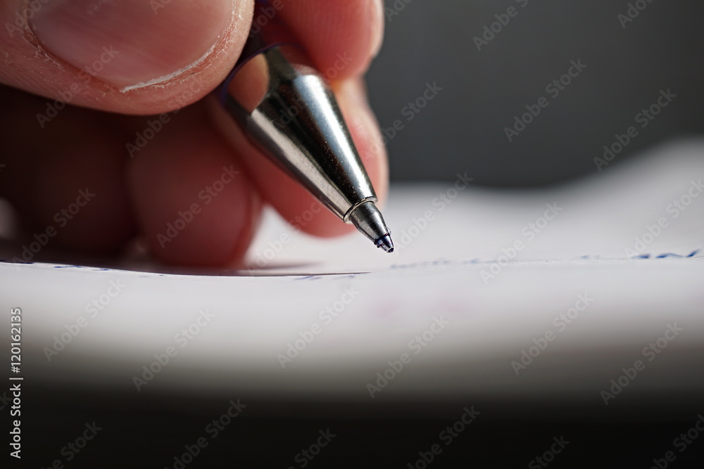 Male hand holding a sharp blue office pen and writing to the white ...