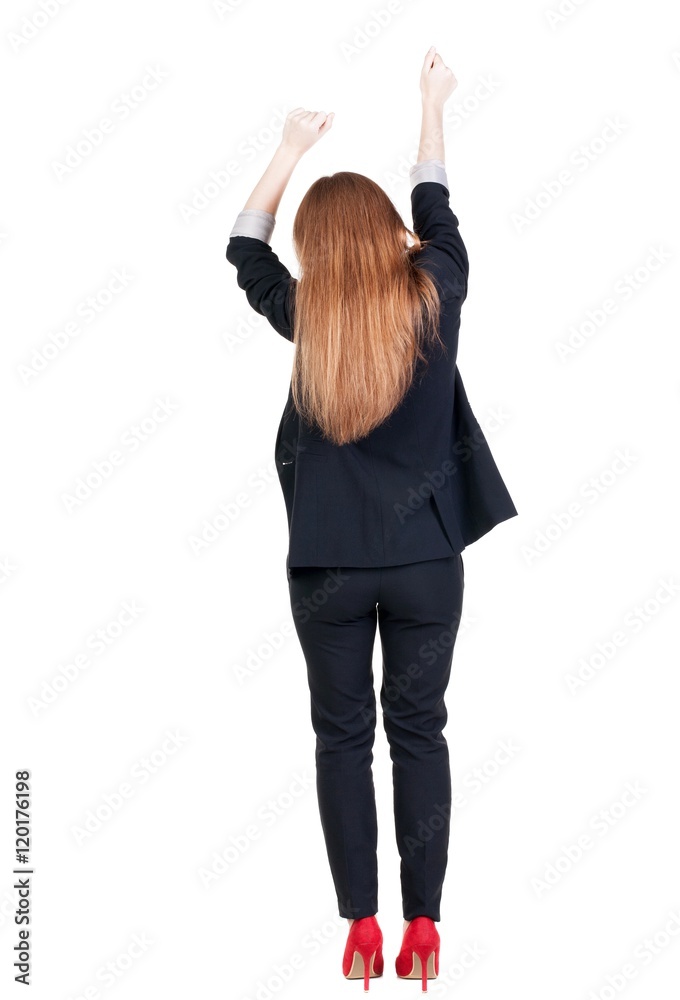 Back view of Beautiful business woman in suite looking at wall and ...