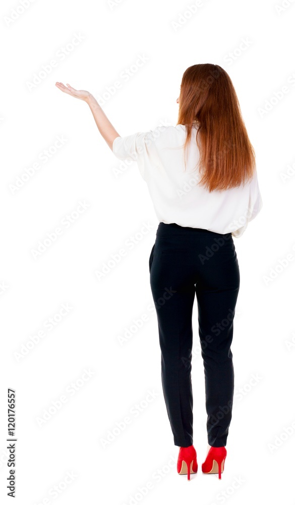 Back view of Beautiful business woman in suite looking at wall and ...