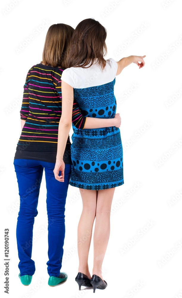 Back view of two young brunette woman pointing . beautiful girl friends ...