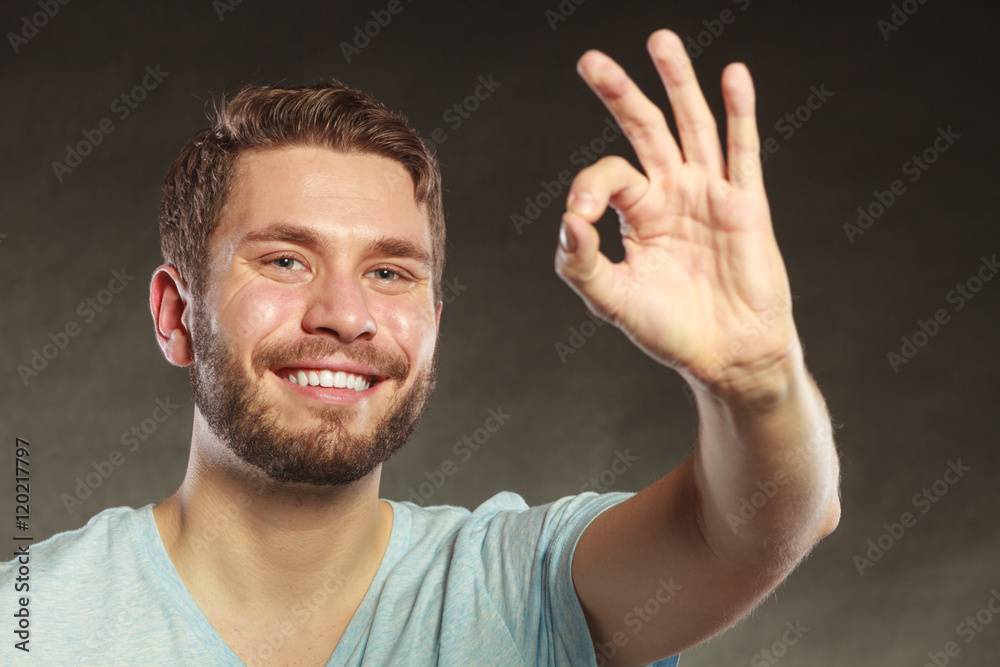 Handsome man guy giving ok sign gesture. Stock Photo | Adobe Stock