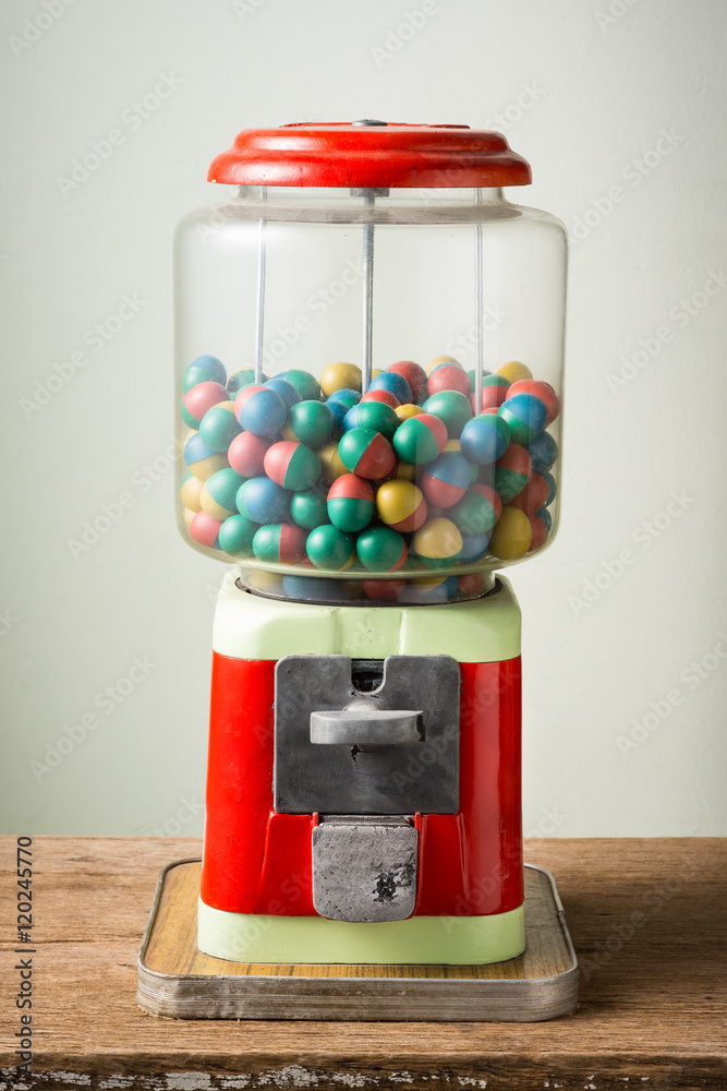 gamble eggs in vintage coin operated gumball machine on old wood Stock ...