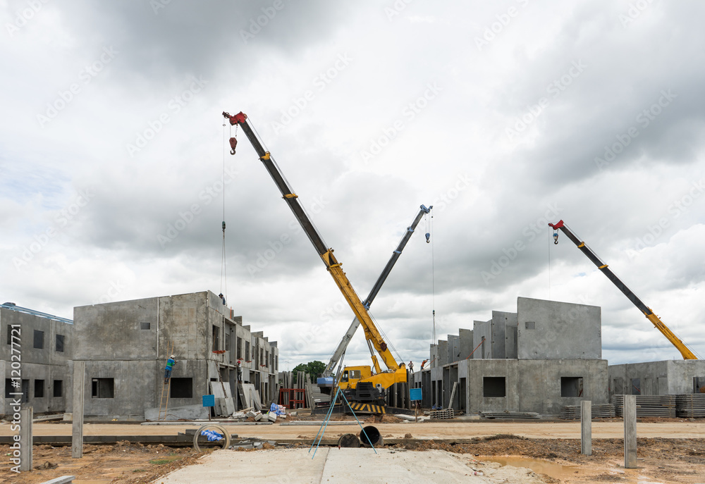 Construction site crane is used to placing precast concrete panels ...