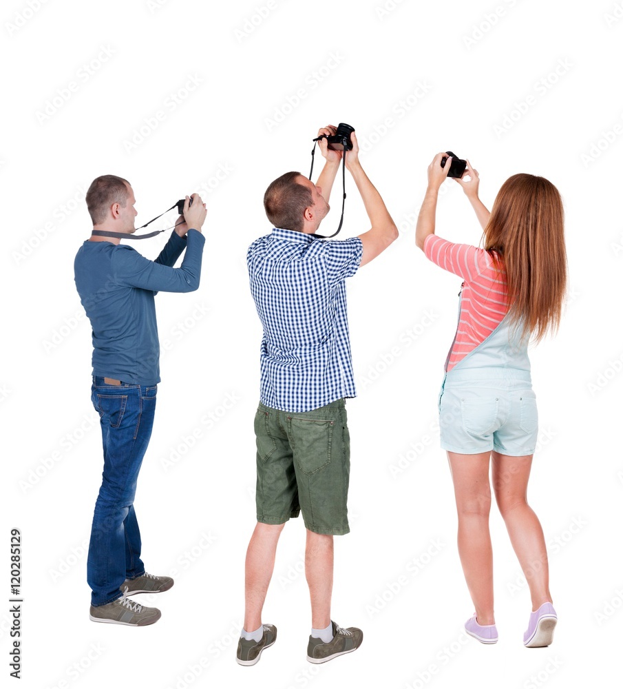 Back view group of people photographed attractions. Rear view team ...