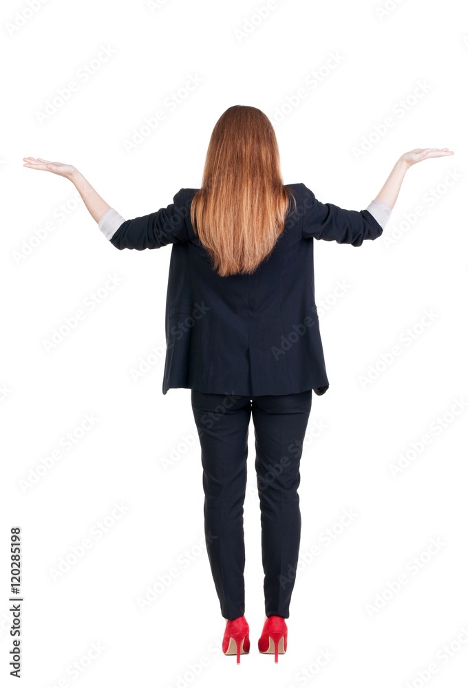 Back view of Beautiful business woman in suite looking at wall and ...