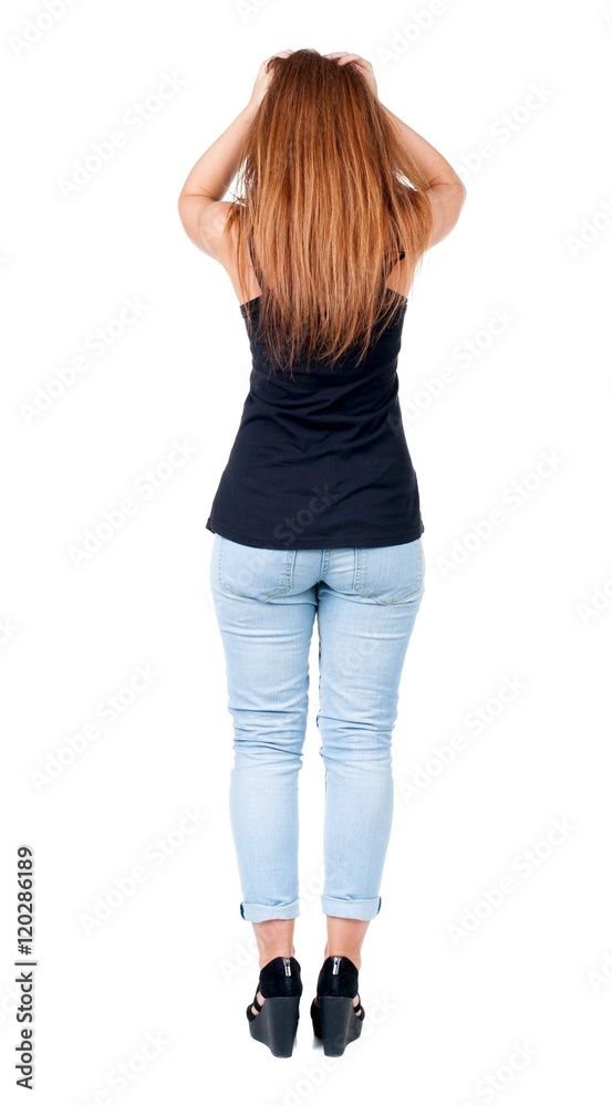 Back view of shocked woman in blue jeans. girl grabbed the hair. Rear ...