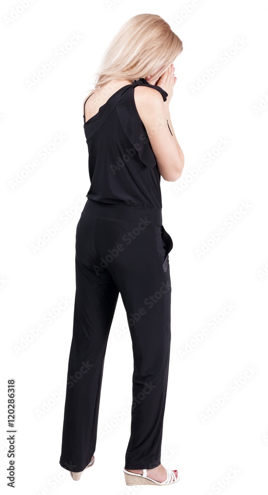 Back view of shocked woman. girl hid his eyes behind his hands. Rear ...