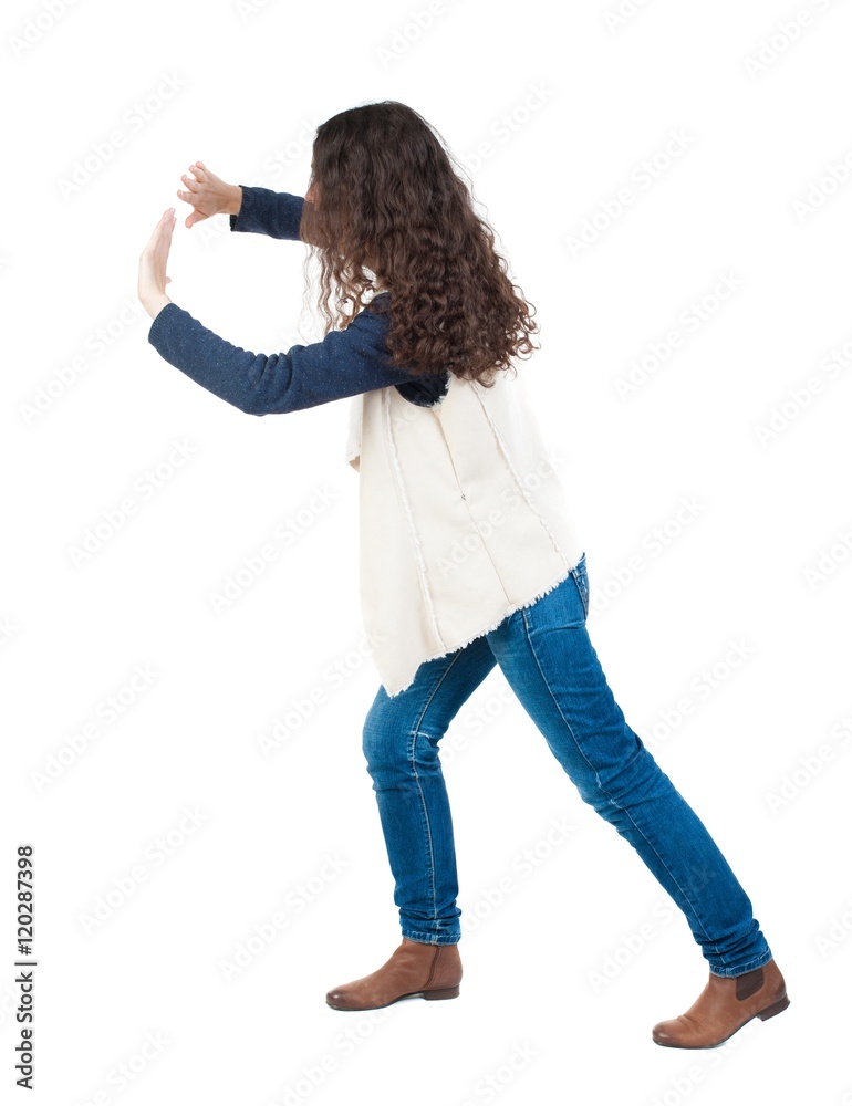 back view of woman pushes wall. Isolated over white background. Rear ...