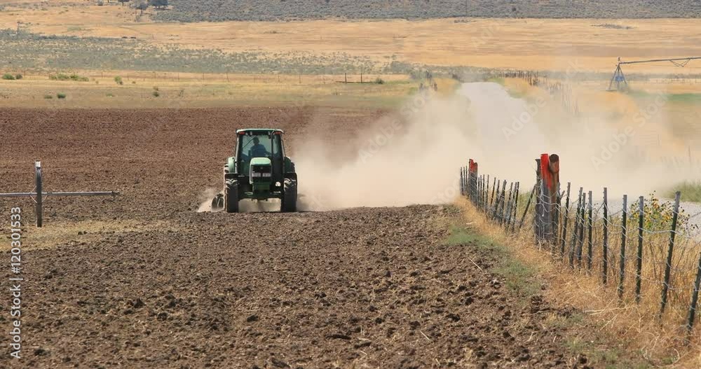 Tractor dusty farm field mountain valley drought. Dry drought dusty ...