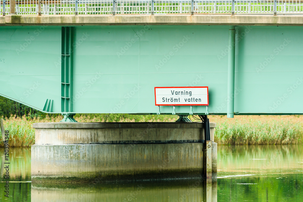 Sign in Swedish on bridge warning about water current. Stock Photo ...