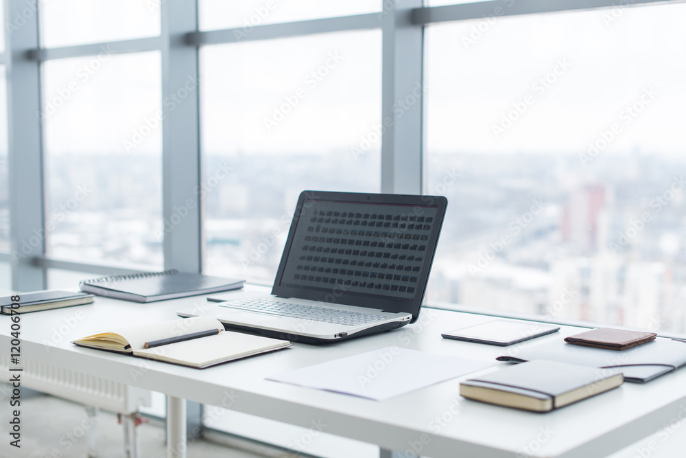 Workplace with notebook laptop Comfortable work table in office windows ...