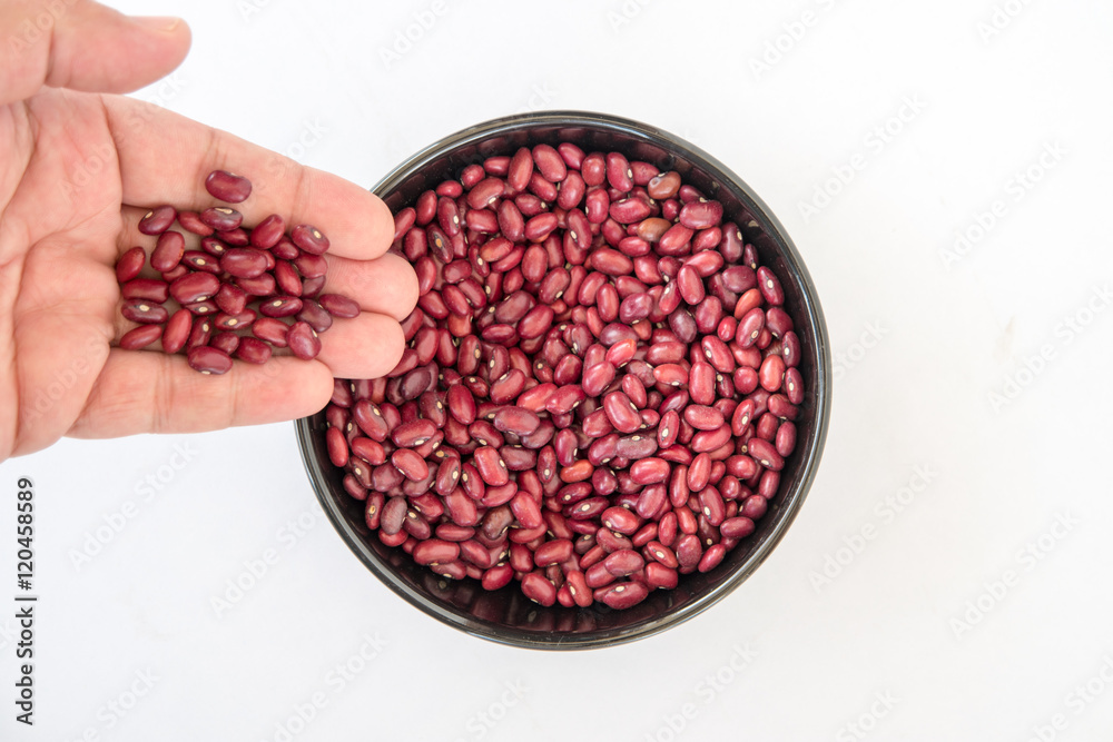 Hand picking up Red kidney bean from a bowl, Also called Rajma or ...