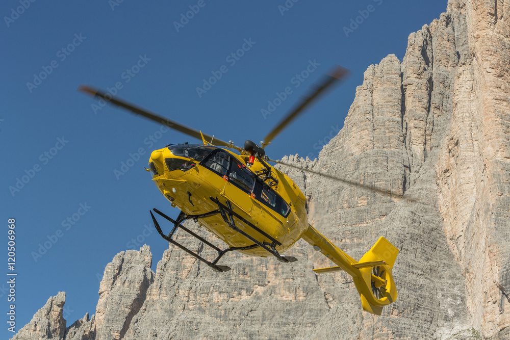 Medical rescue helicopter flying rescue injured climber on the Tre Cime ...