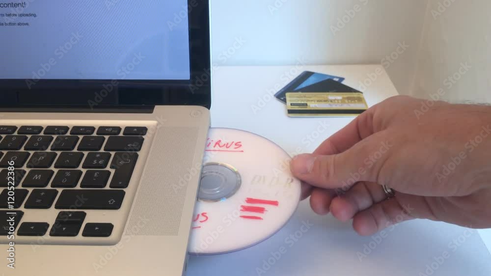 Hacker Installing a Computer Virus In Dvd, Crime Scene. A computer ...