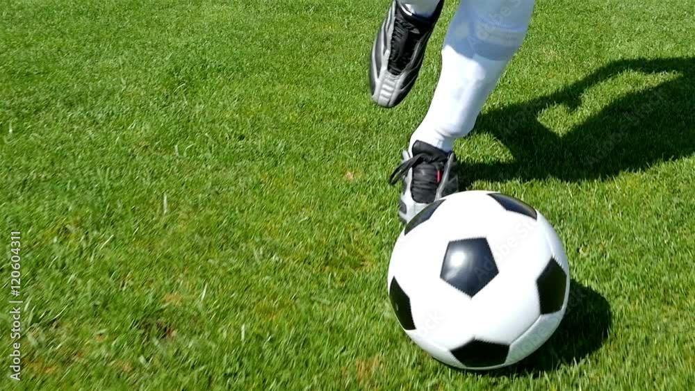 Footballer leading the ball on a football field, slow motion Stock ...
