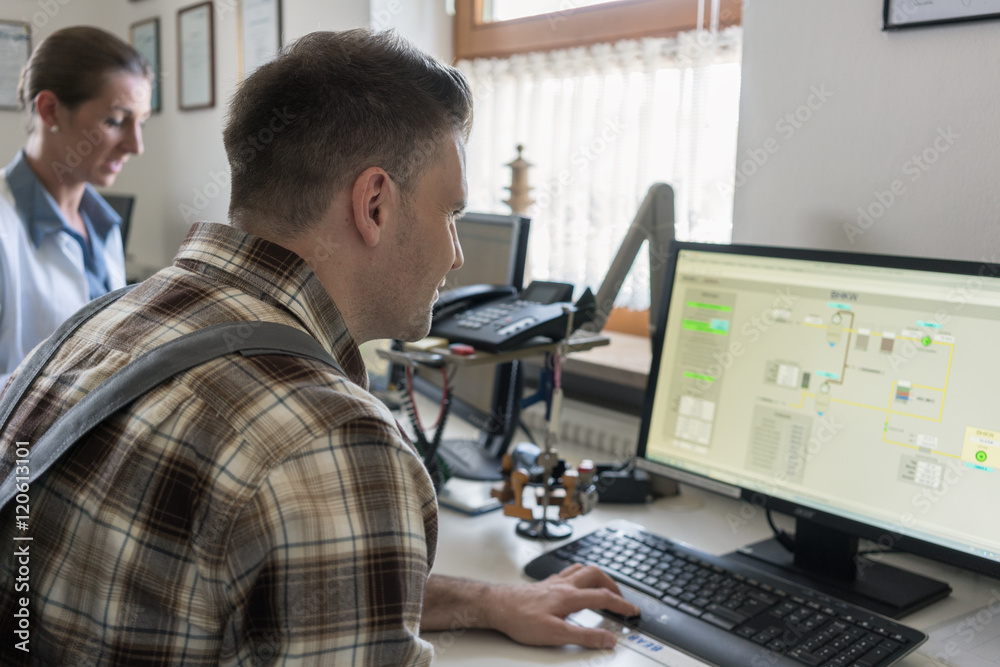 Foto de Man and woman in control room of water purification plant ...