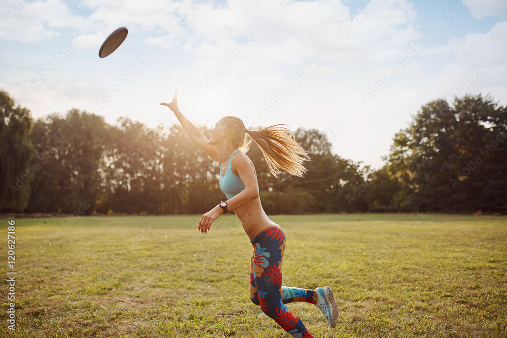 Young athletic girl playing frisbee Stock Photo | Adobe Stock