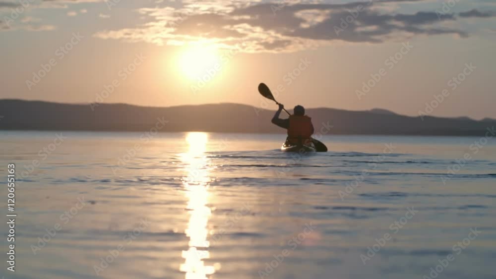 Rear view slow motion of tourist paddling with forward sweep strokes on ...