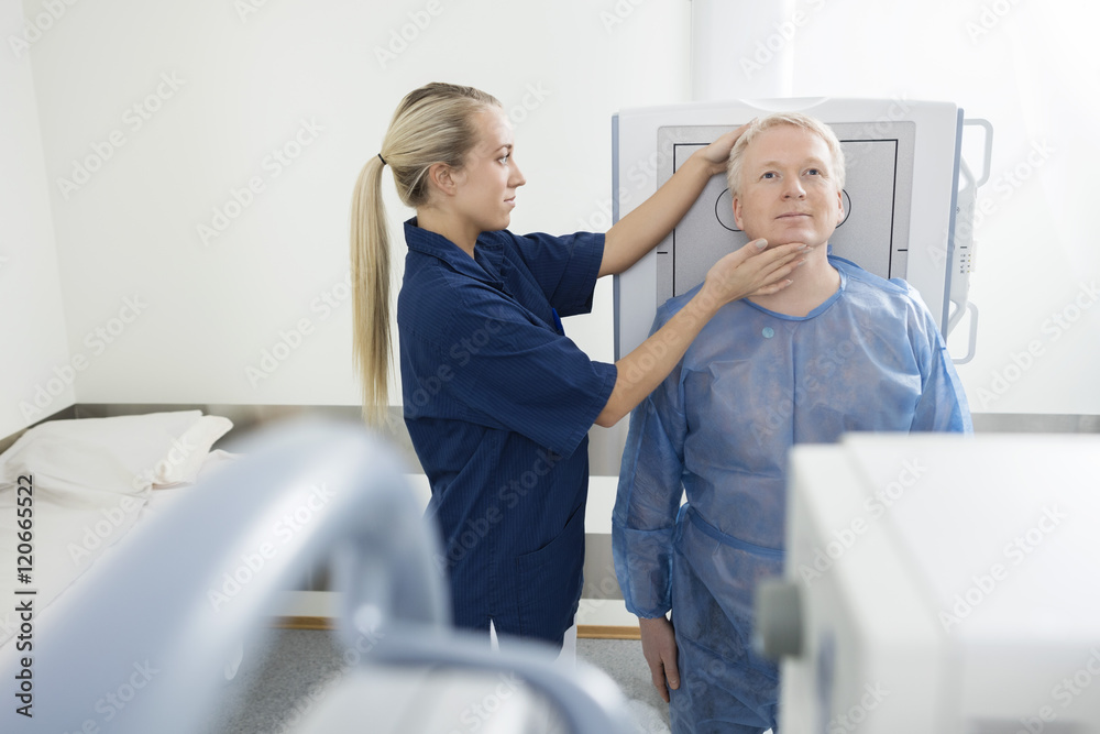 Radiologist Adjusting Head Of Patient Before Taking Xray In Clin Stock ...