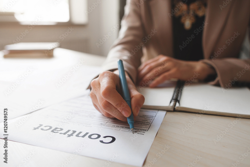 Female hand with pen completing personal information on form. Business ...