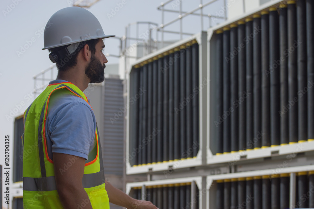 Mechanical engineer during a site visit, checking cooling towers ...