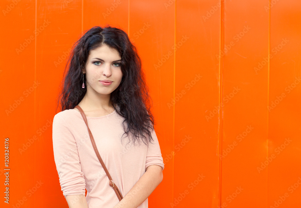 Beautiful tall girl with long hair brunette standing near background ...