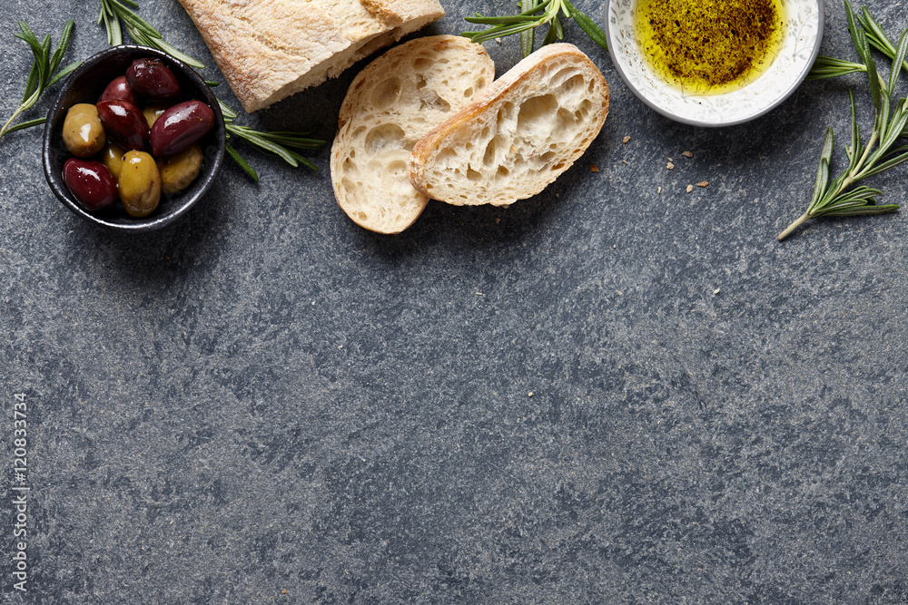 Italian food background with ciabatta bread, olive oil, olives and ...