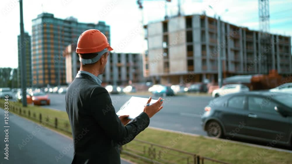 4k, Ultra HD. Young attractive engineer works outdoor on newly ...