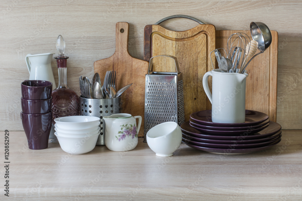 Crockery, tableware, utensils and other different stuff on wooden table ...