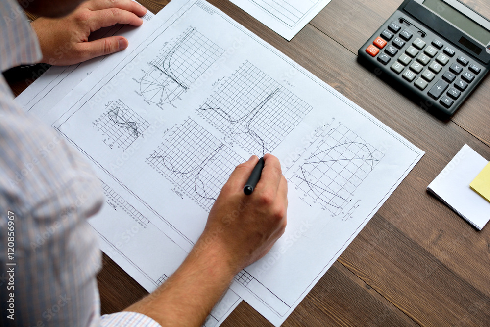 Mechanical engineer at work. Technical drawings. Paper with technical ...
