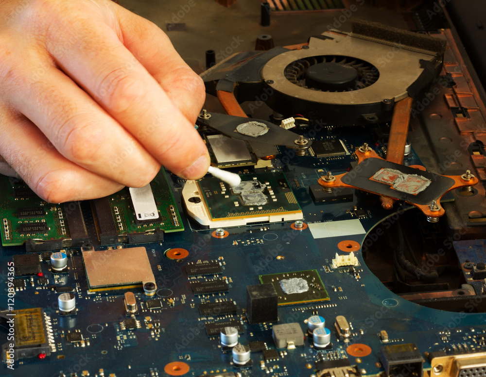 computer repair. Remove old thermal paste on the laptop processor ...