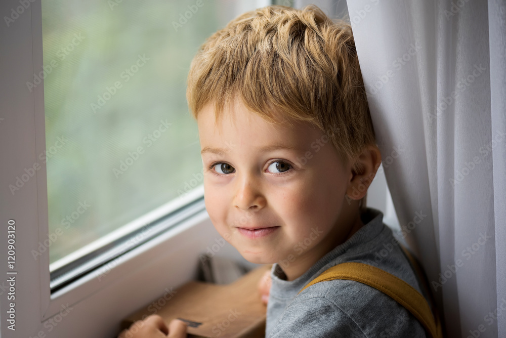 Little kid boy standing near window and smiling Stock Photo | Adobe Stock