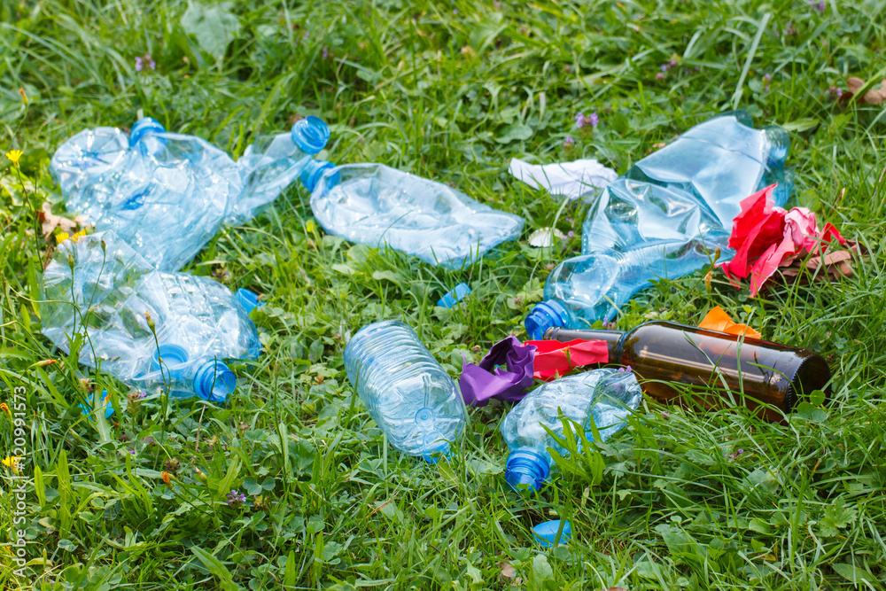 Heap of rubbish on grass in park, littering of environment Stock Photo ...