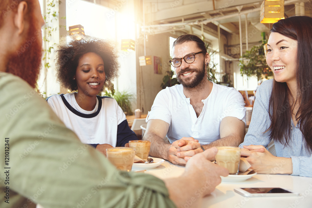 Friendship and communication concept. Four young people of diverse ...