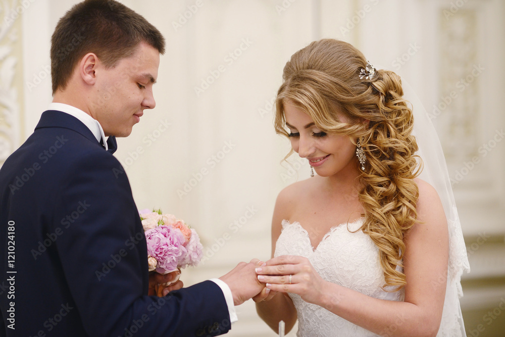Beauty bride and handsome groom are wearing rings each other. Wedding ...