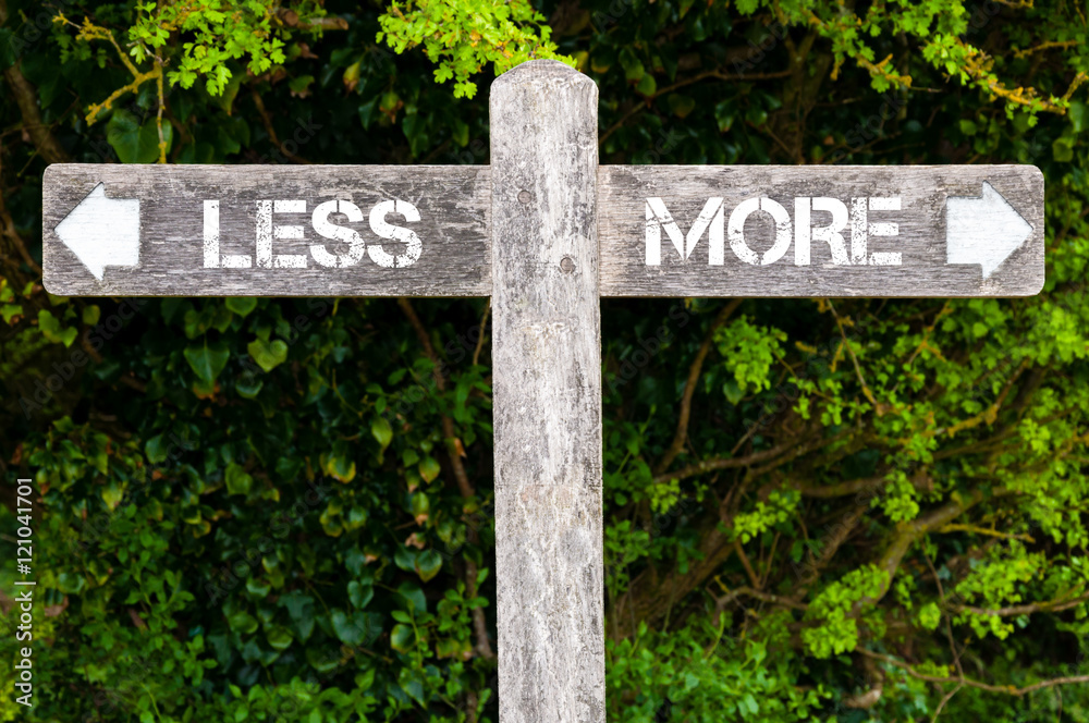 LESS versus MORE directional signs Stock Photo | Adobe Stock