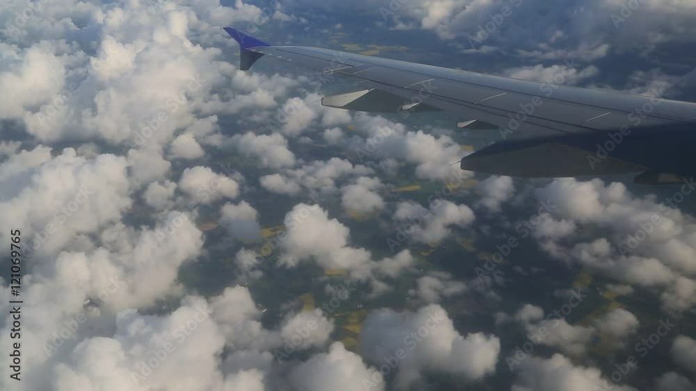 Scene from window of airplane. Clouds and landforms. Countryside and ...