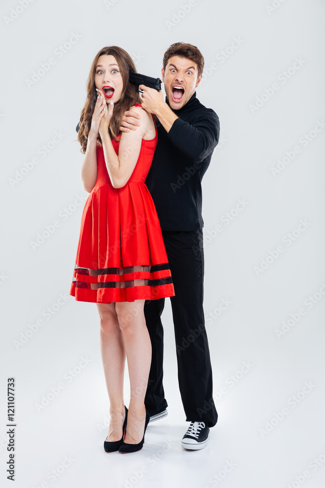 Aggressive man shouting and threatening to woman with gun Stock Photo ...