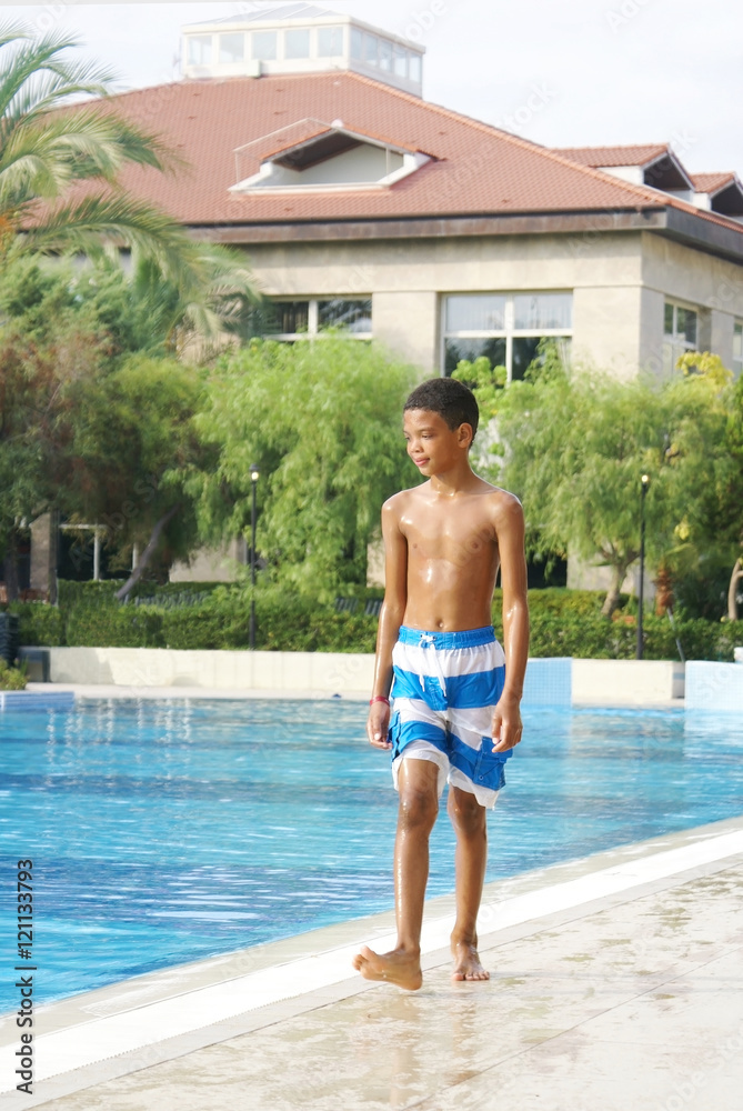 Boy at swimming pool. Stock Photo | Adobe Stock