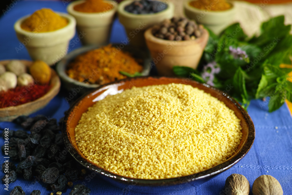 Organic yellow couscous and different spices in traditional oriental ...