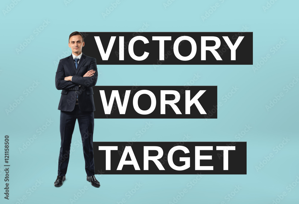 Businessman standing confidently with a motto 'victory work target ...