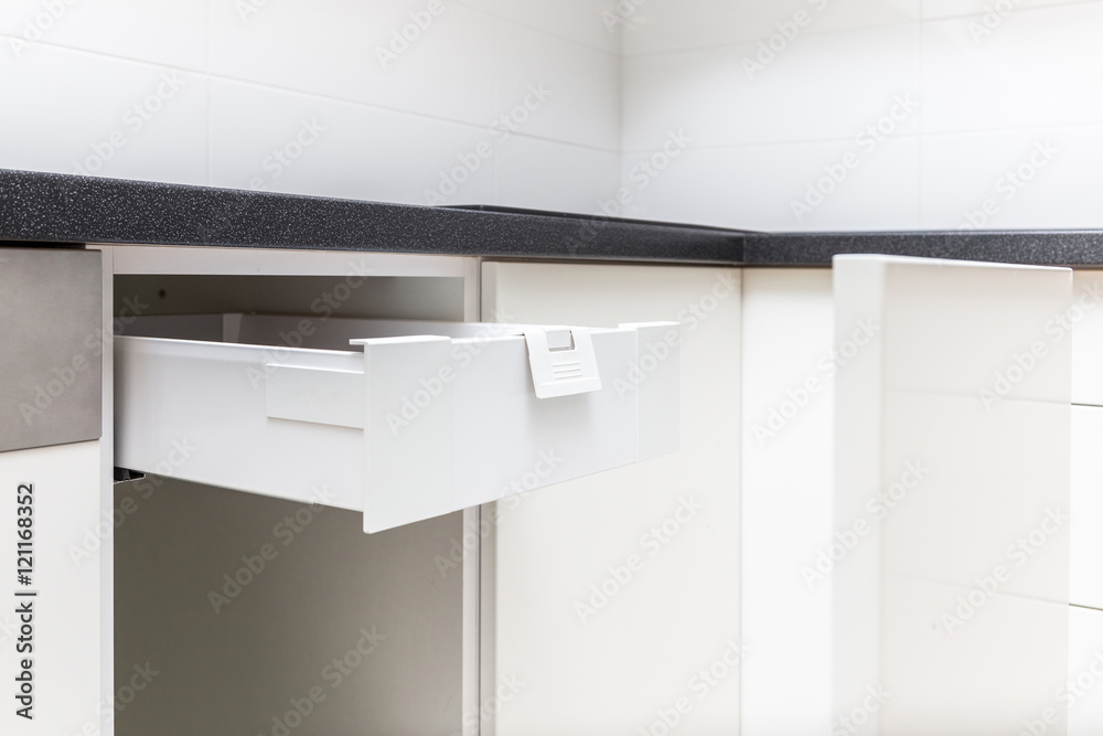 Opened kitchen drawer with high front for garbage bin and inner drawer ...