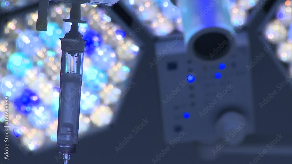 Intravenous drip pull focus to surgery light. Hand switches light on ...