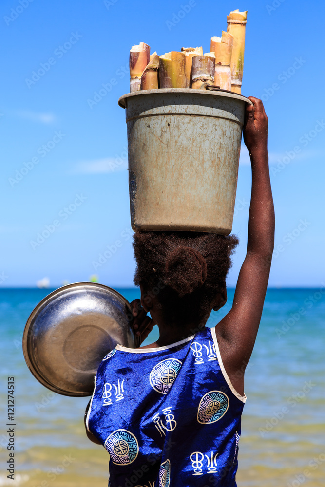 Young girl carrying a heavy bucket with bamboo on her head Stock Photo ...