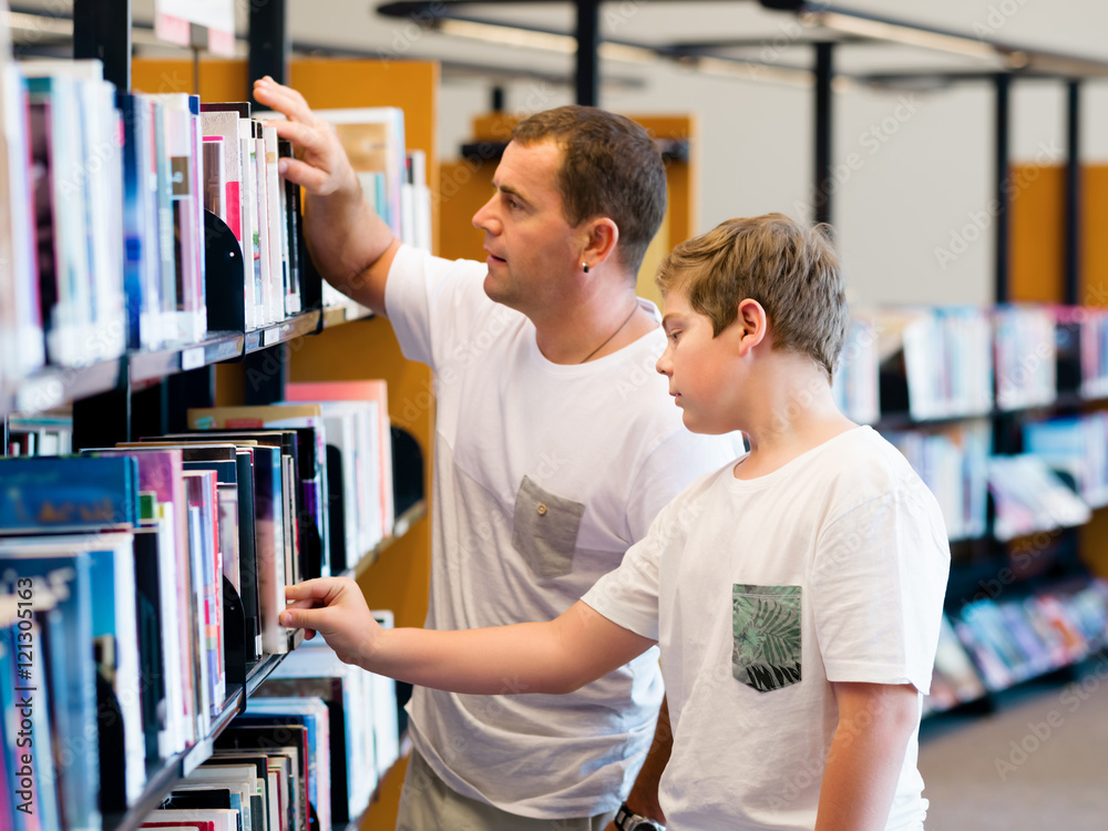 Boy and his father in library Stock Photo | Adobe Stock